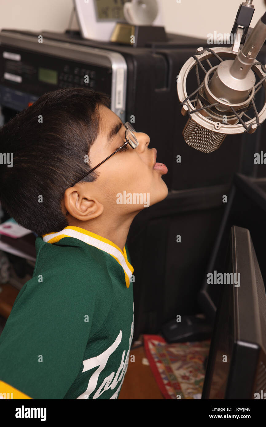 Boy disc jockey singing into a microphone Stock Photo - Alamy