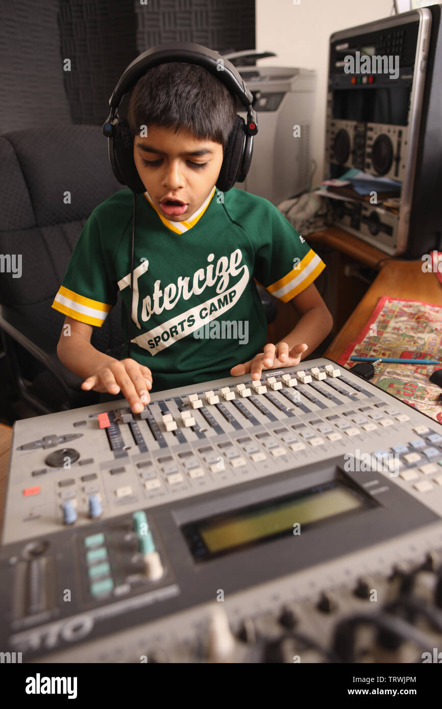 Boy disc jockey using a sound board Stock Photo - Alamy