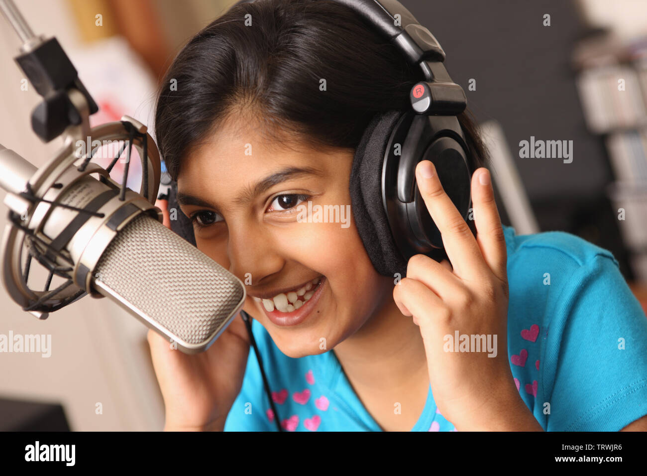 Girl disc jockey speaking into a microphone Stock Photo - Alamy