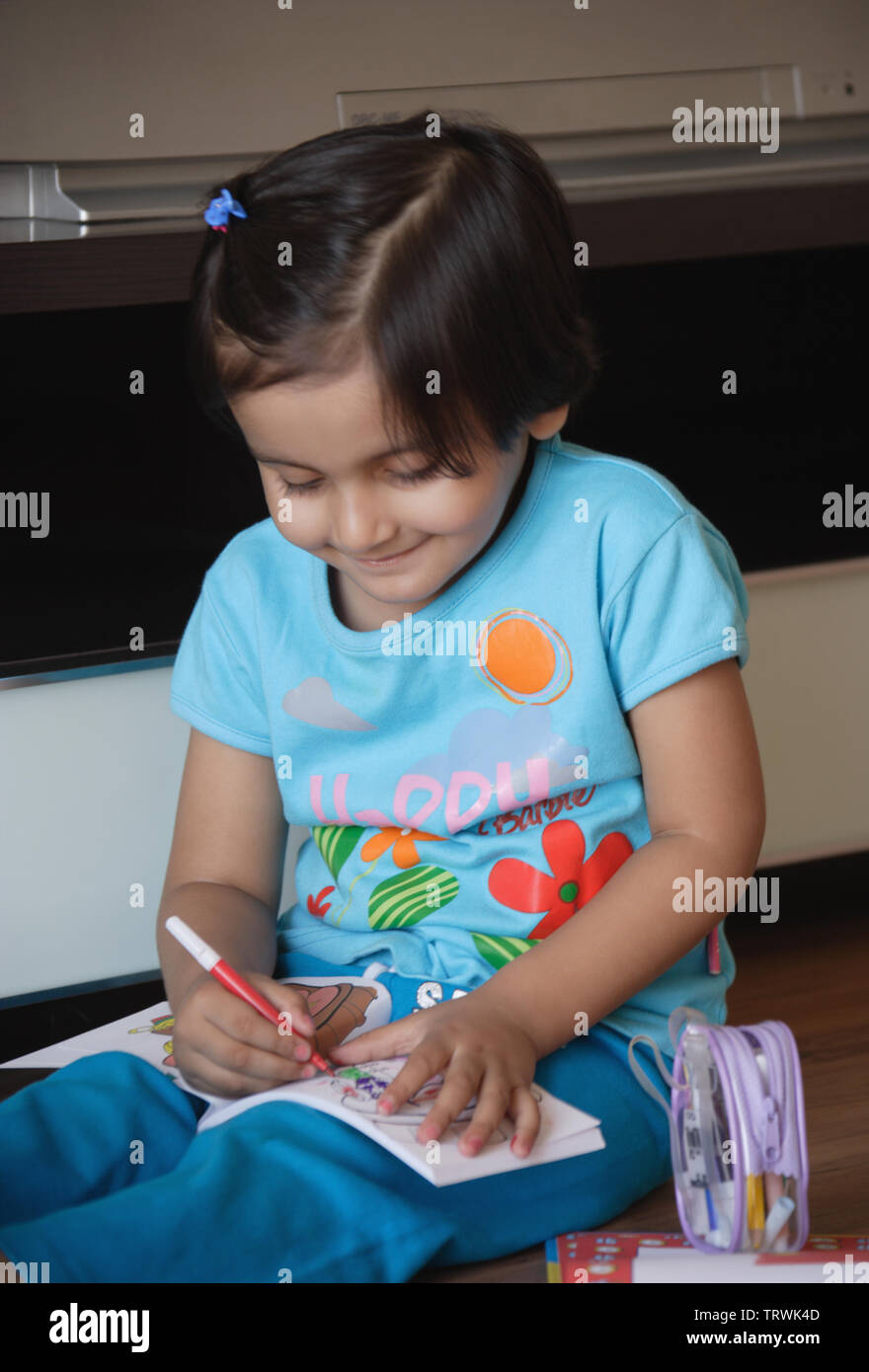 Black child colouring in a book hi-res stock photography and images - Alamy