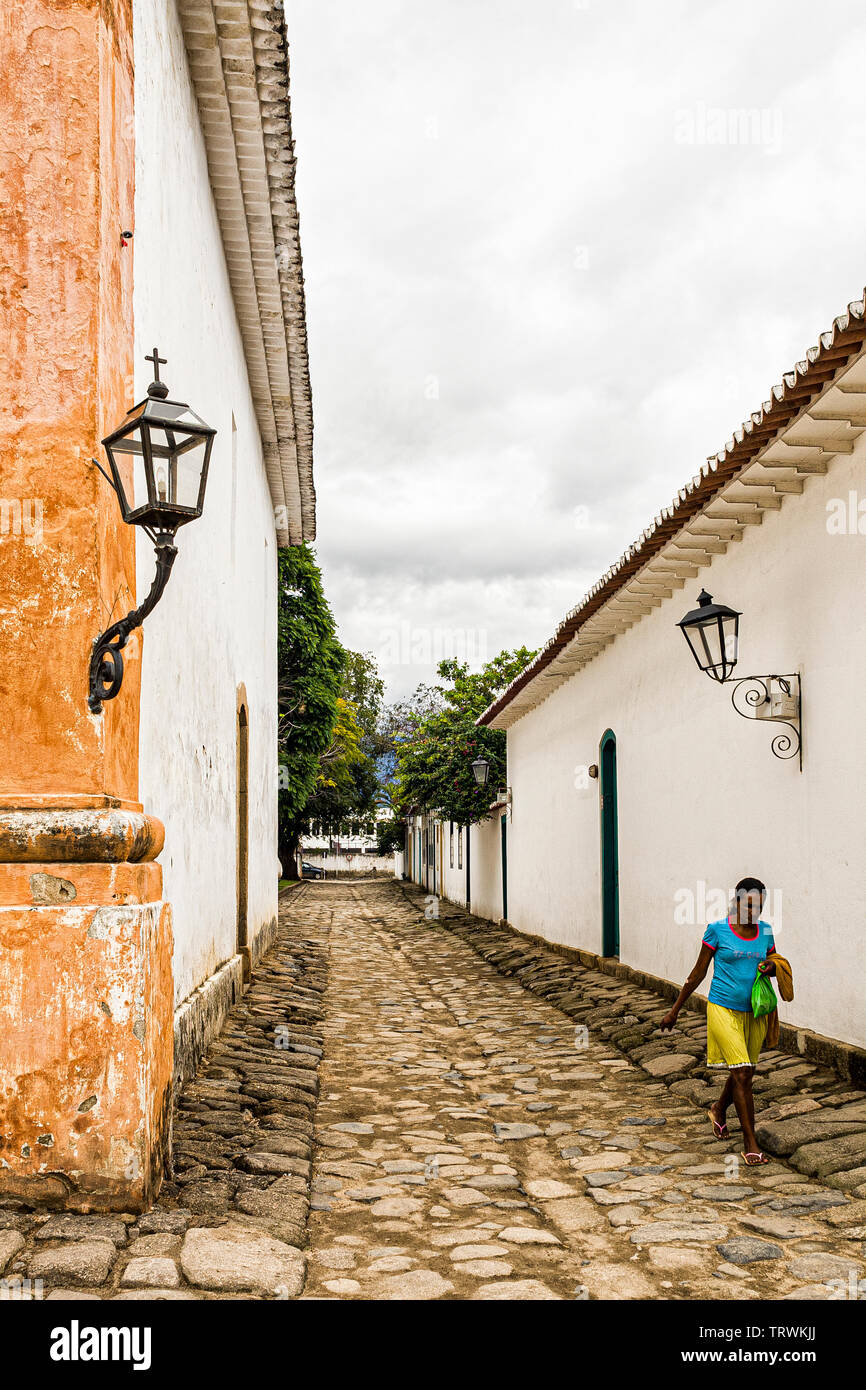 Cobblestone paved street and colonial architecture houses in the ...