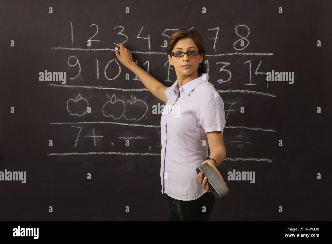 Woman teaching in a classroom Stock Photo - Alamy
