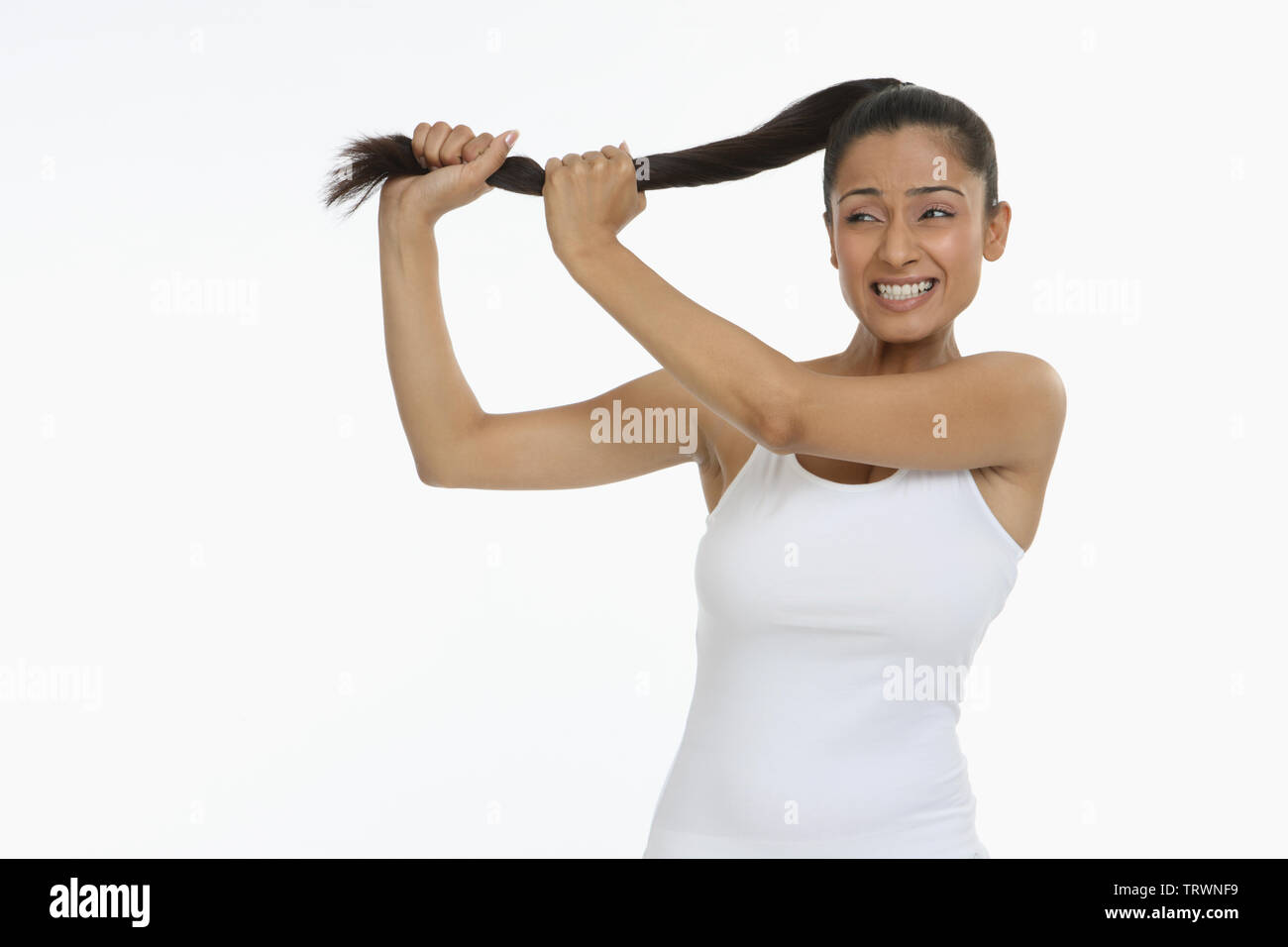 Woman pulling her hair Stock Photo - Alamy