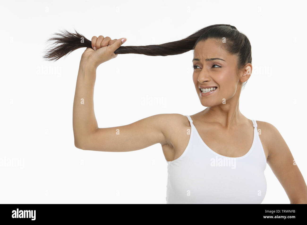 Woman pulling her hair Stock Photo - Alamy