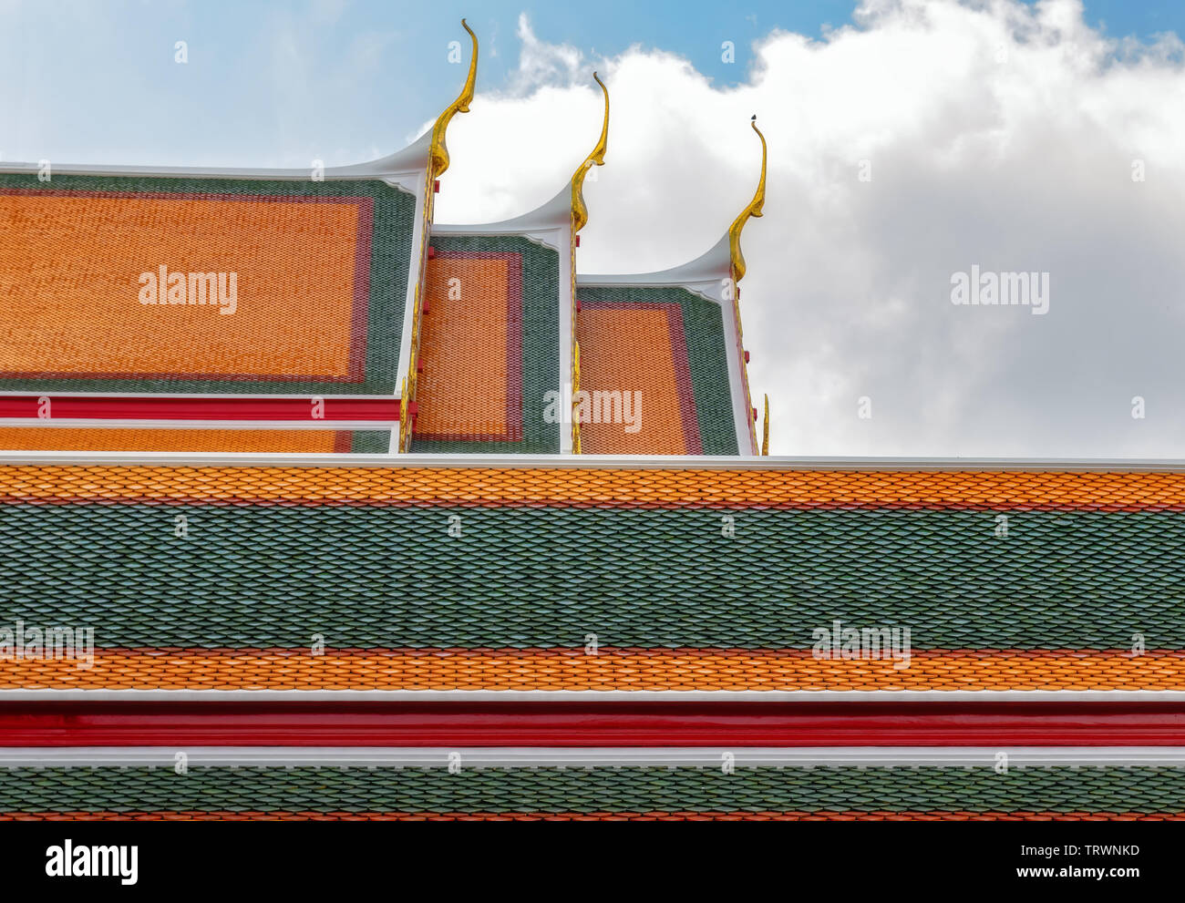 Colorful roofs of the temple in Bangkok on a background of blue sky ...