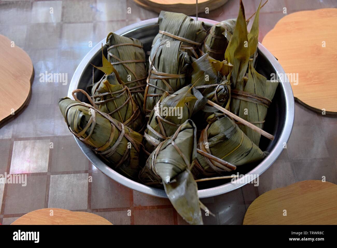Zongzi is a traditional Chinese sticky rice dish with pyramid shaped ...