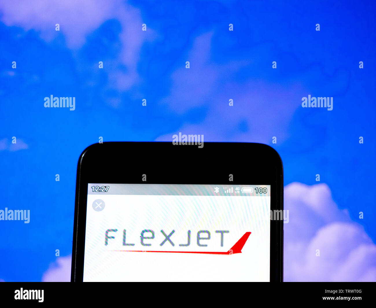 In this photo illustration the Flexjet logo is seen displayed on a smartphone Stock Photo - Alamy