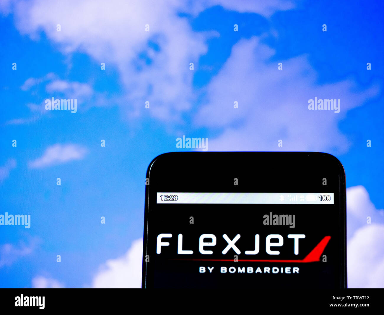 In this photo illustration the Flexjet logo is seen displayed on a smartphone Stock Photo - Alamy