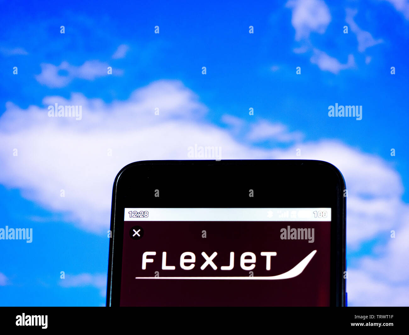In this photo illustration the Flexjet logo is seen displayed on a smartphone Stock Photo - Alamy