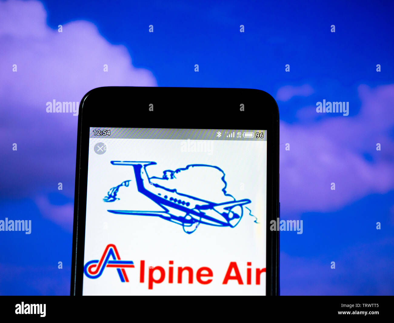 In this photo illustration the Alpine Air Express logo is seen ...