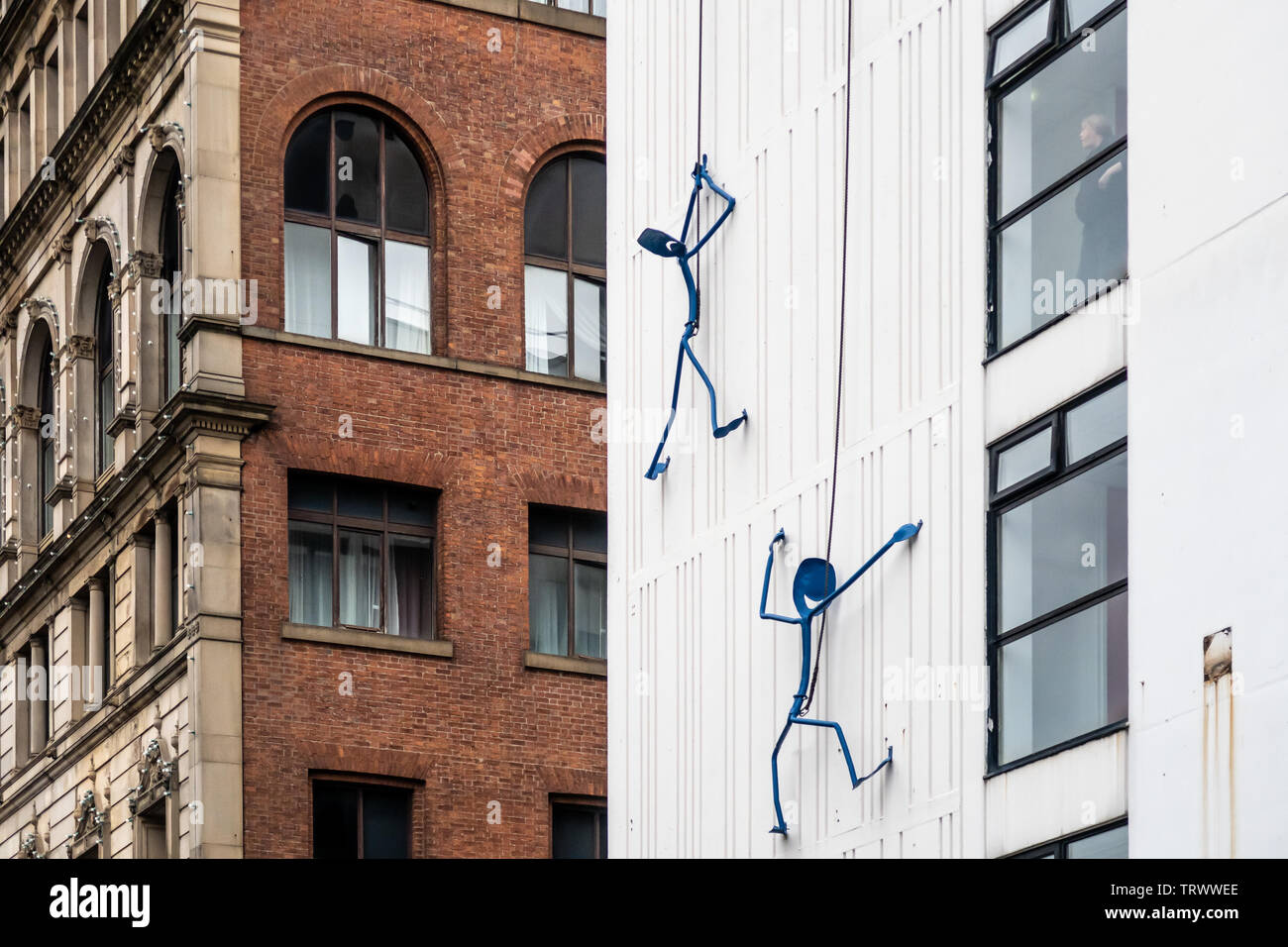 Stick Men climbing up Arthur House on Chorlton Street, Manchester ...