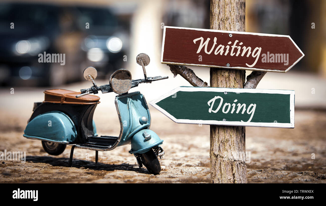 Street Sign the Direction Way to Doing versus Waiting Stock Photo - Alamy