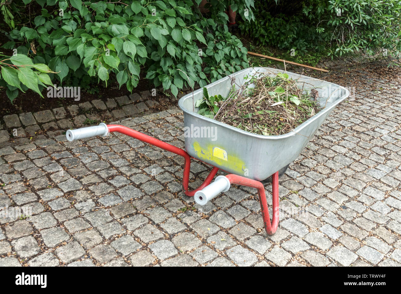Garden wheelbarrow, Garden maintenance Stock Photo - Alamy