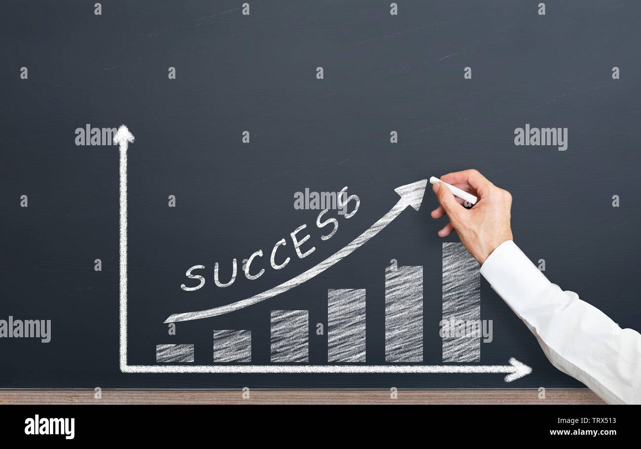 man is drawing success graph on chalkboard. success concept Stock Photo ...