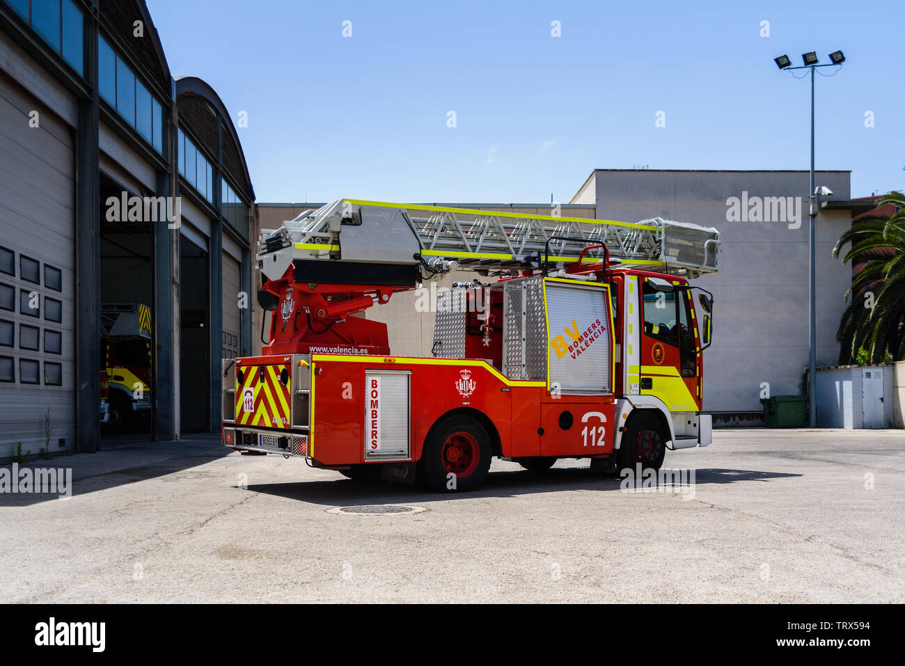 Valencia, Spain - June 8, 2019: Fire truck with ladder leaving the fire ...