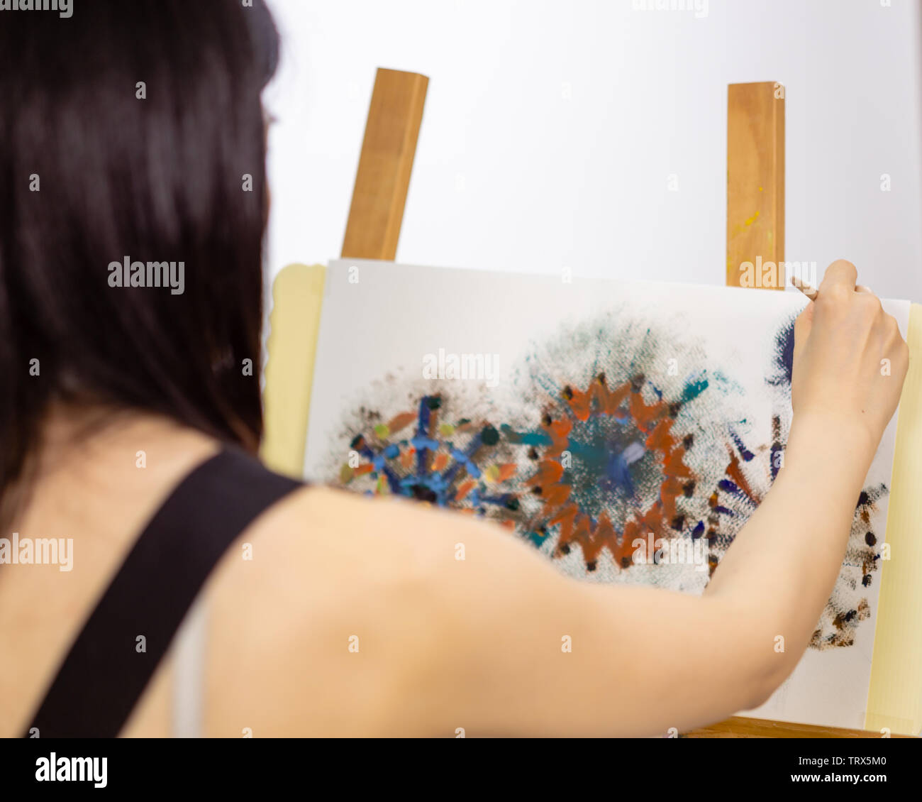Artist painting on an easel, OTS shot Stock Photo - Alamy