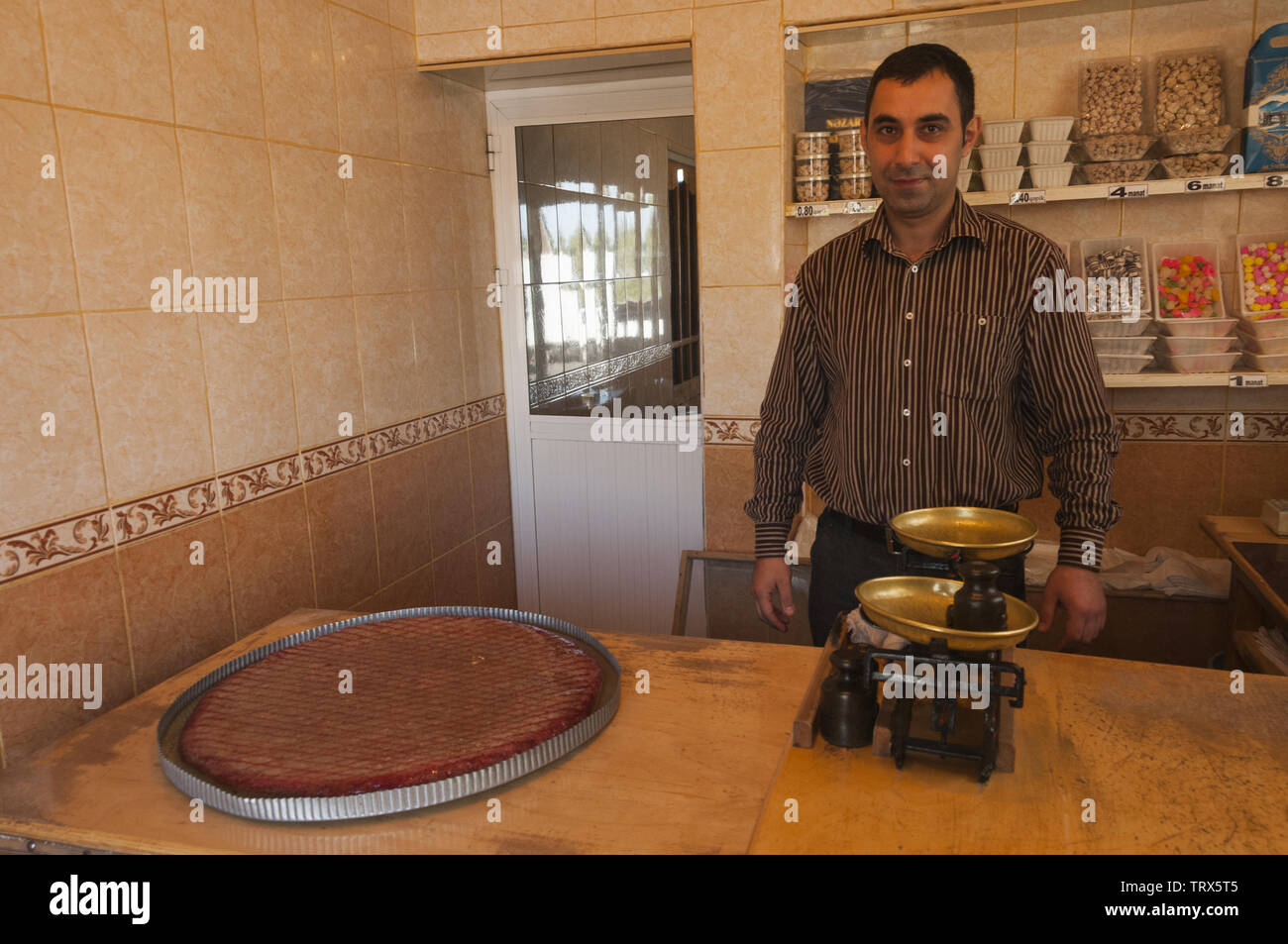 Azerbaijan, Sheki (Shaki), halva bakery, interior with proprietor and ...