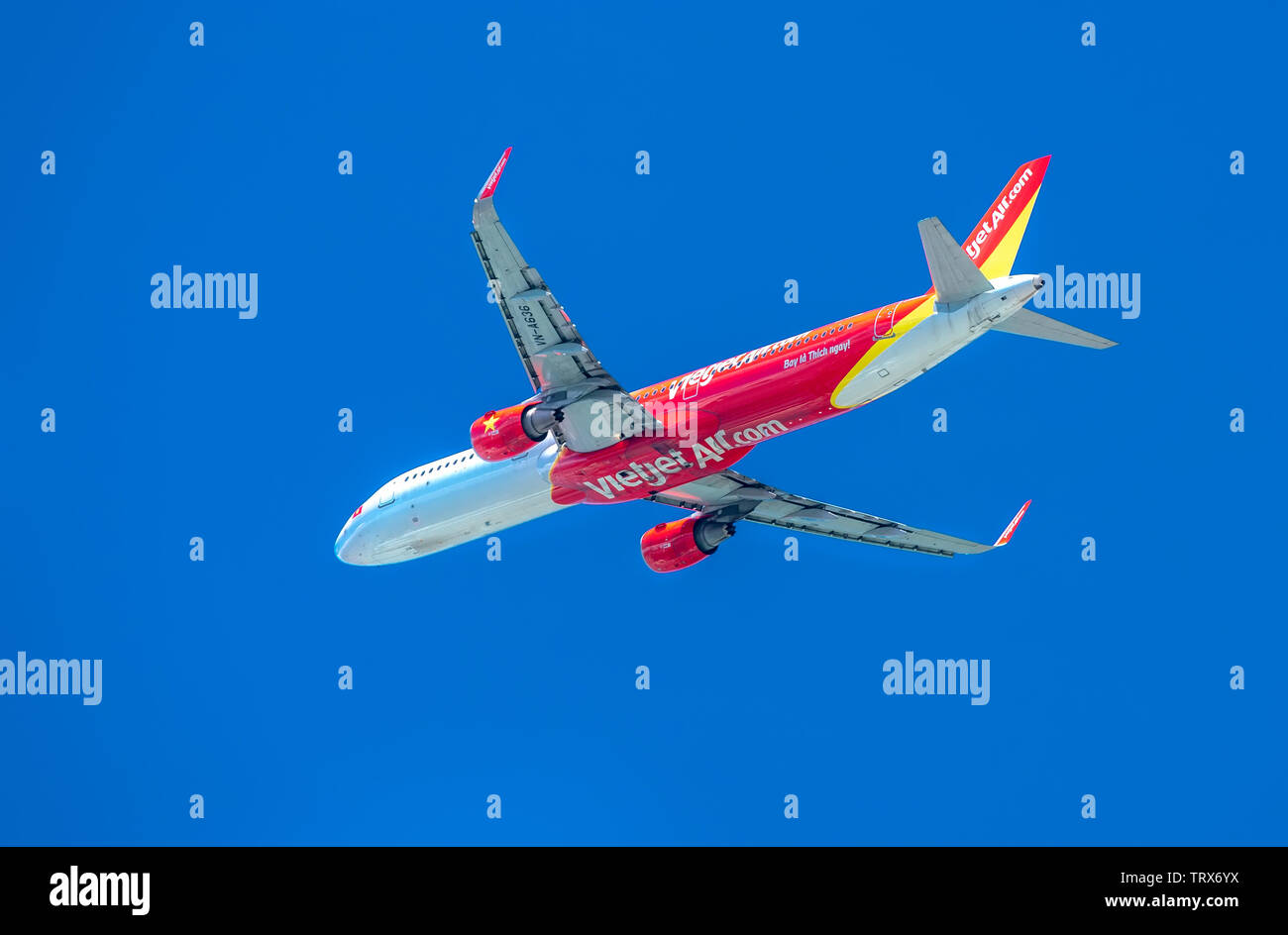 Passenger airplane Airbus A321 of VietJet Air flying through sky take ...