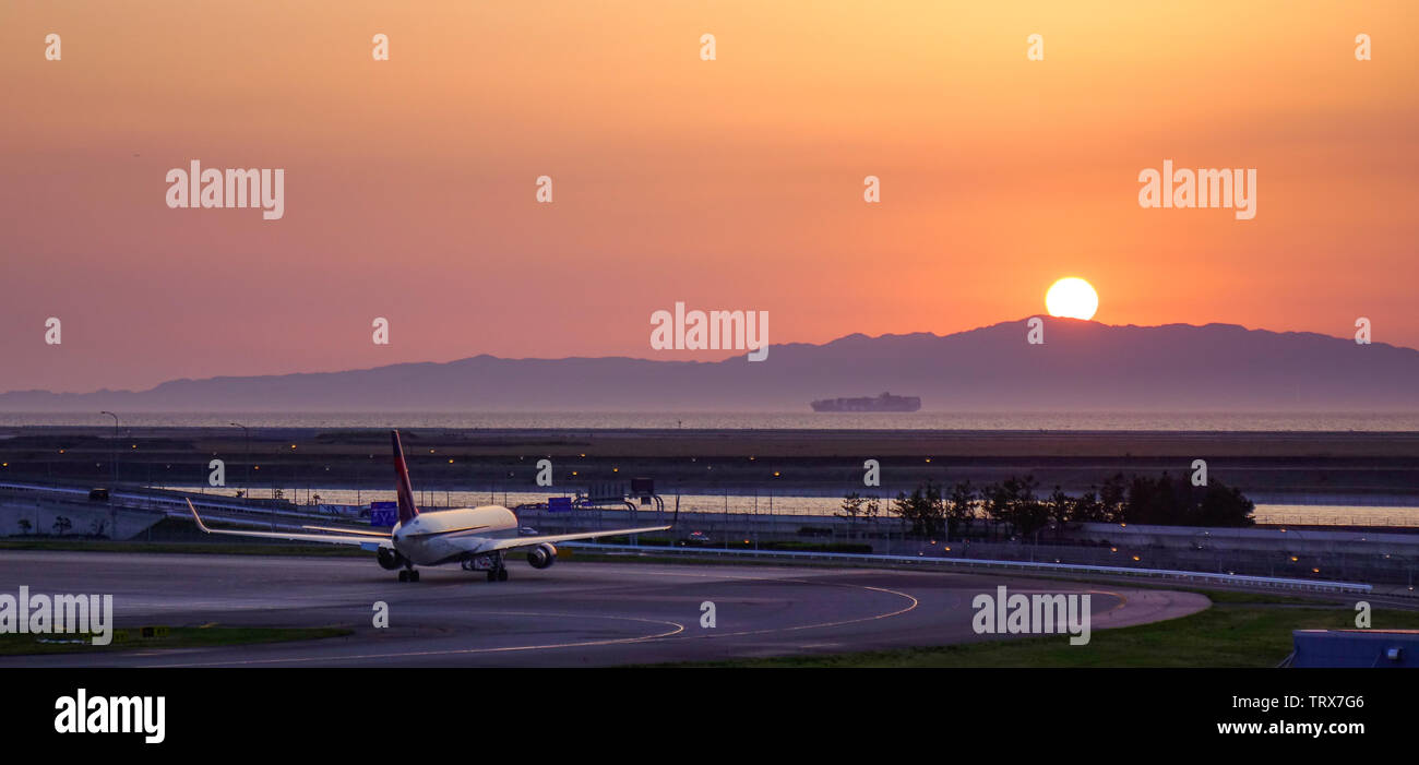 Osaka, Japan - Apr 19, 2019. Passenger airplanes taxiing on runway of ...
