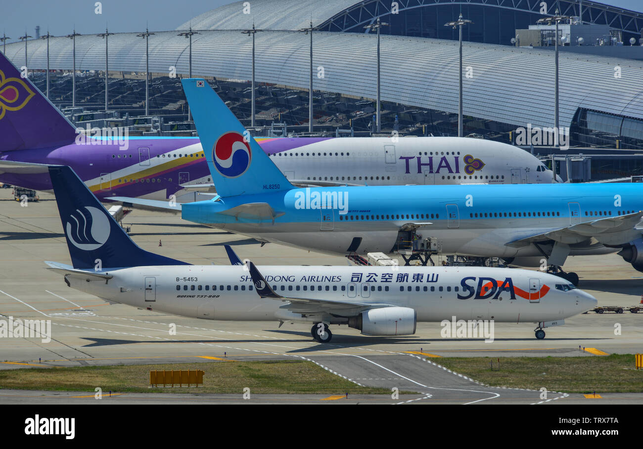Osaka, Japan - Apr 19, 2019. Passenger airplanes taxiing on runway of ...
