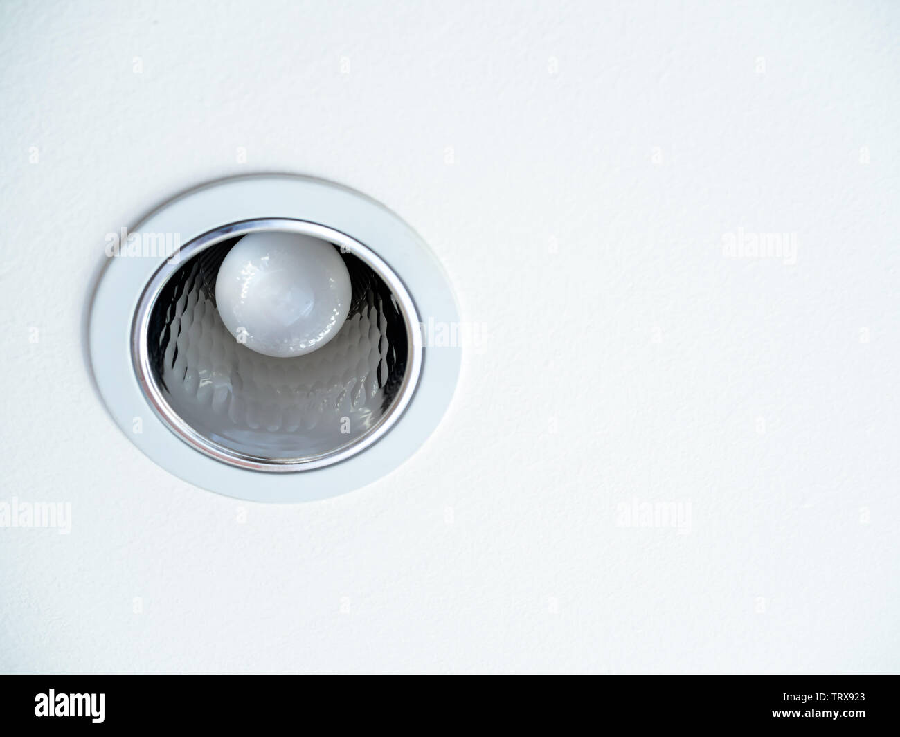 Close-up LED ceiling light. Downlight with light bulb on white ceiling ...