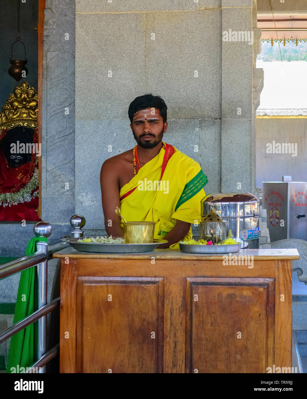 A hindu priest at Deviramma Temple in traditional attire with copy ...