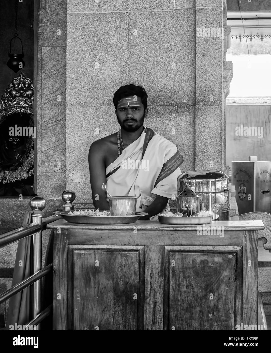 A hindu priest at Deviramma Temple in traditional attire with copy ...