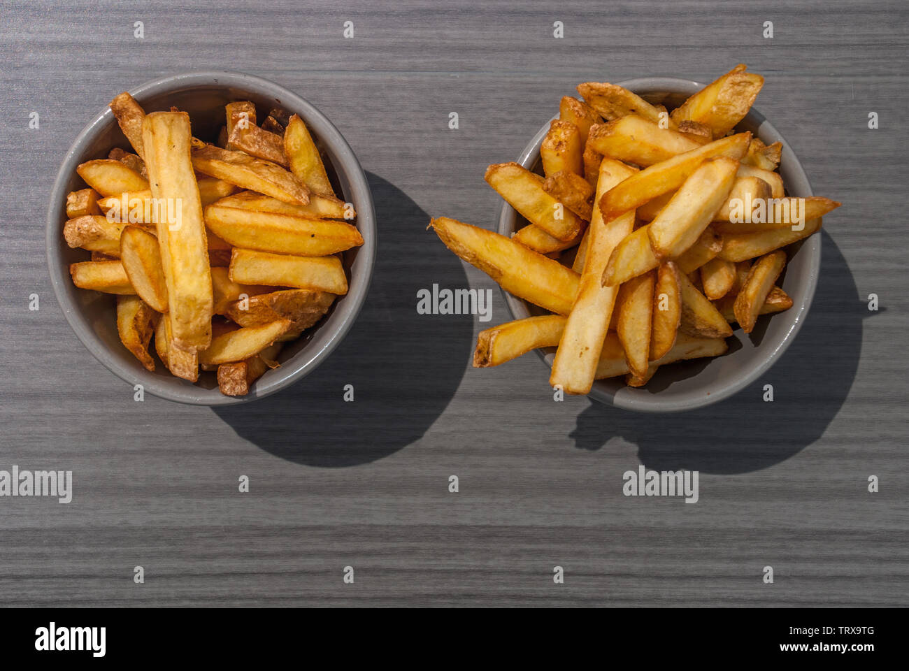 Tasty french fries in a cup on a 2 gray cup Stock Photo - Alamy