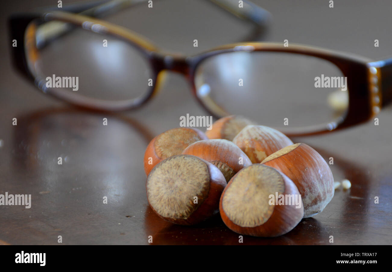 Hazelnut Table With pair of lenses on the Background Stock Photo - Alamy