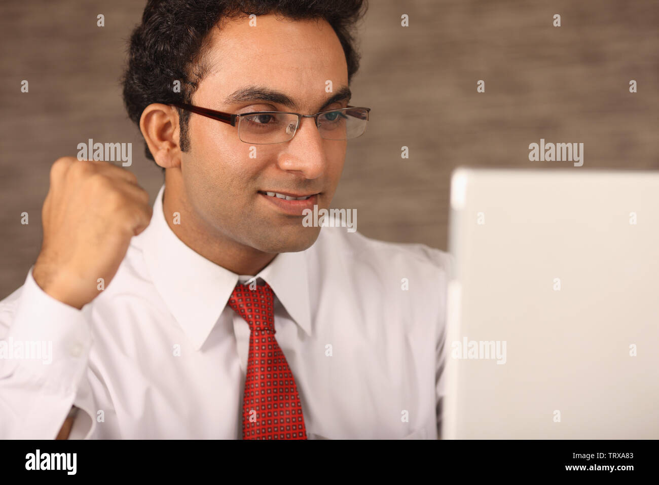 Indian businessman working on a laptop Stock Photo - Alamy