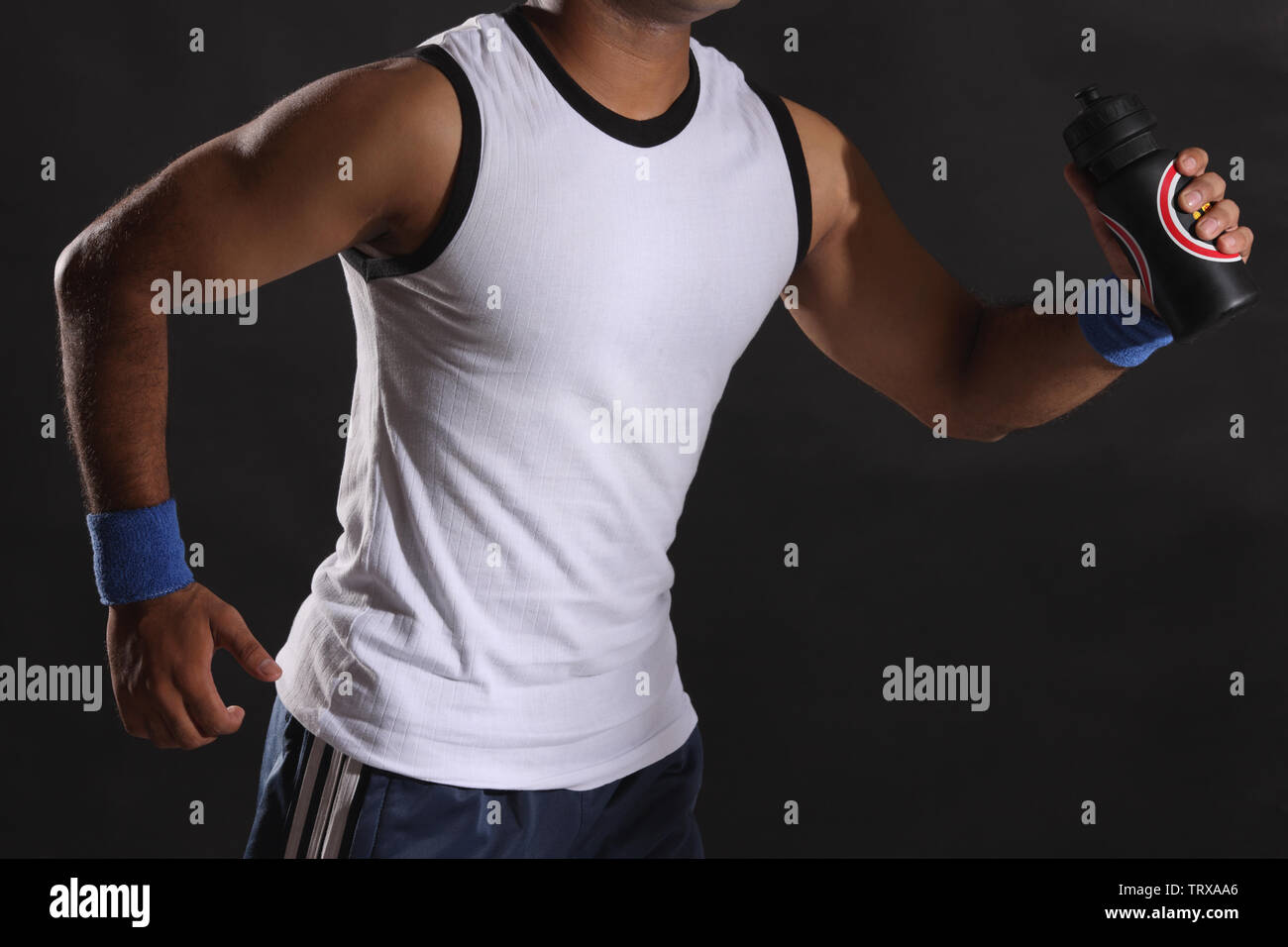Male athlete holding a sport drink Stock Photo - Alamy