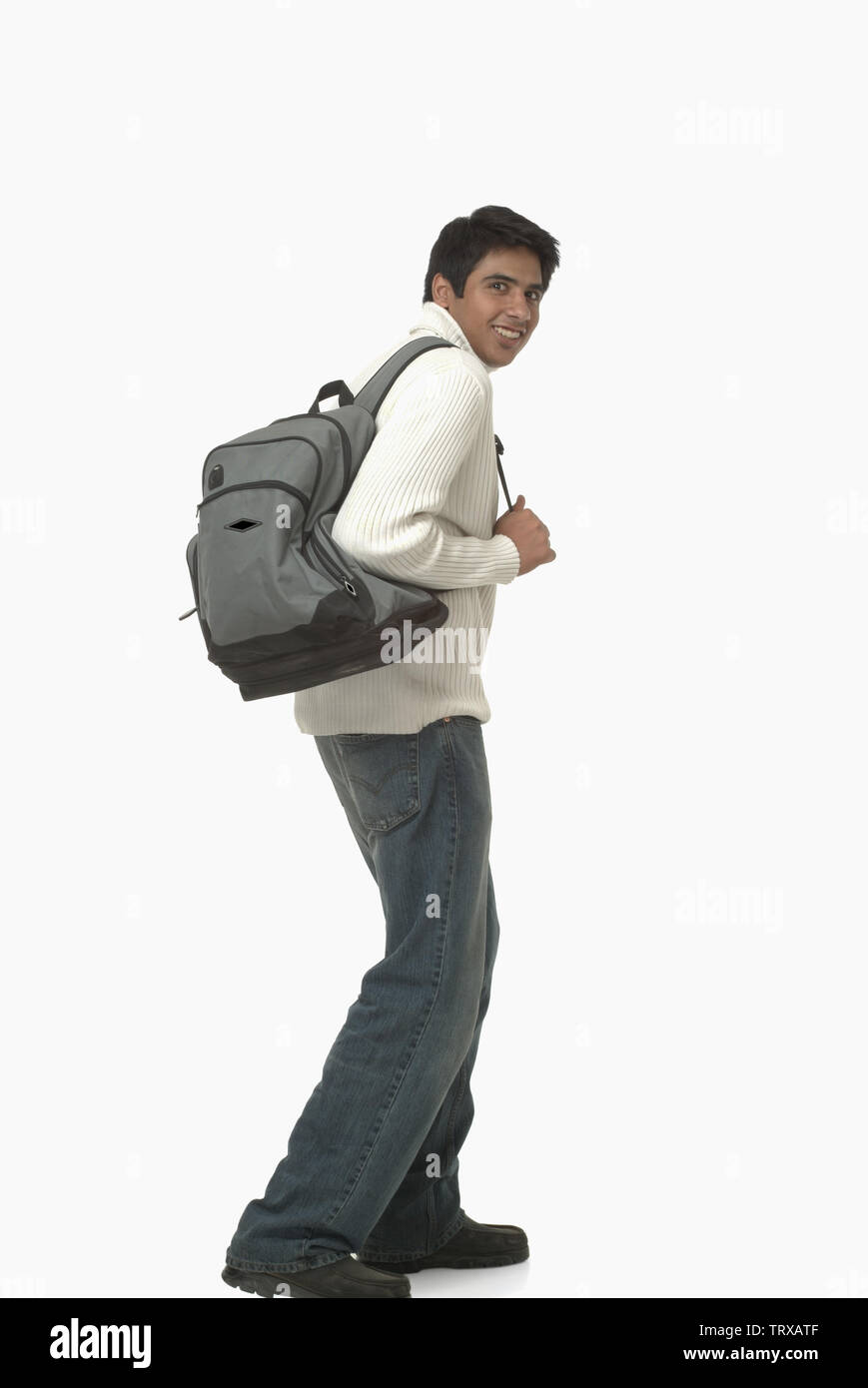 College student walking and smiling Stock Photo - Alamy