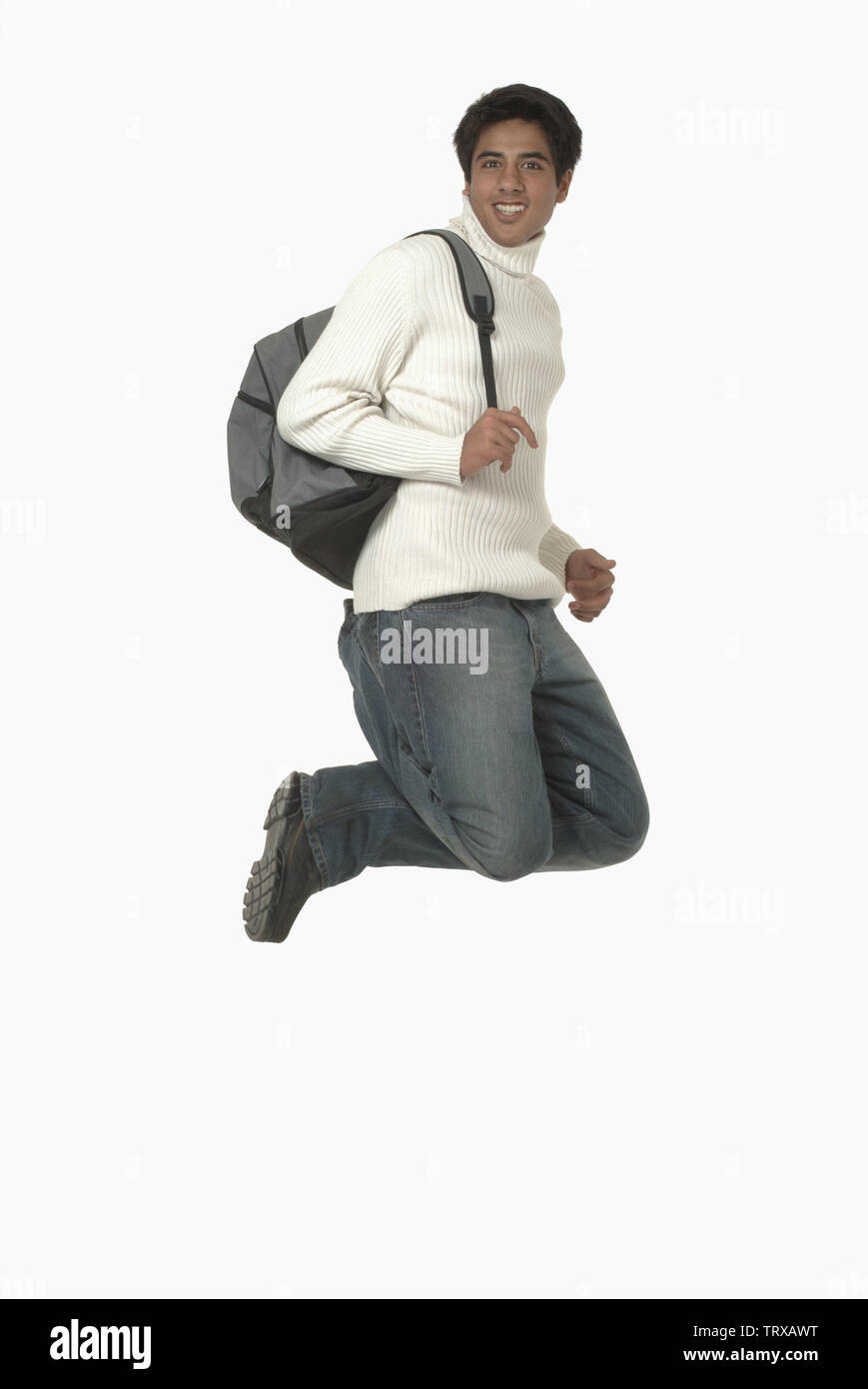 College student jumping and smiling Stock Photo - Alamy
