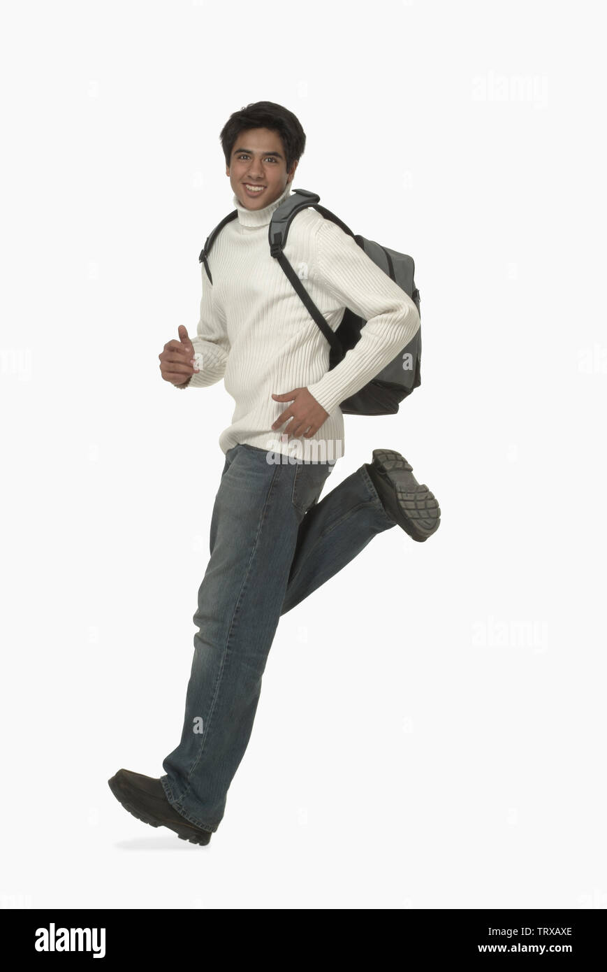 College student running with a backpack Stock Photo - Alamy