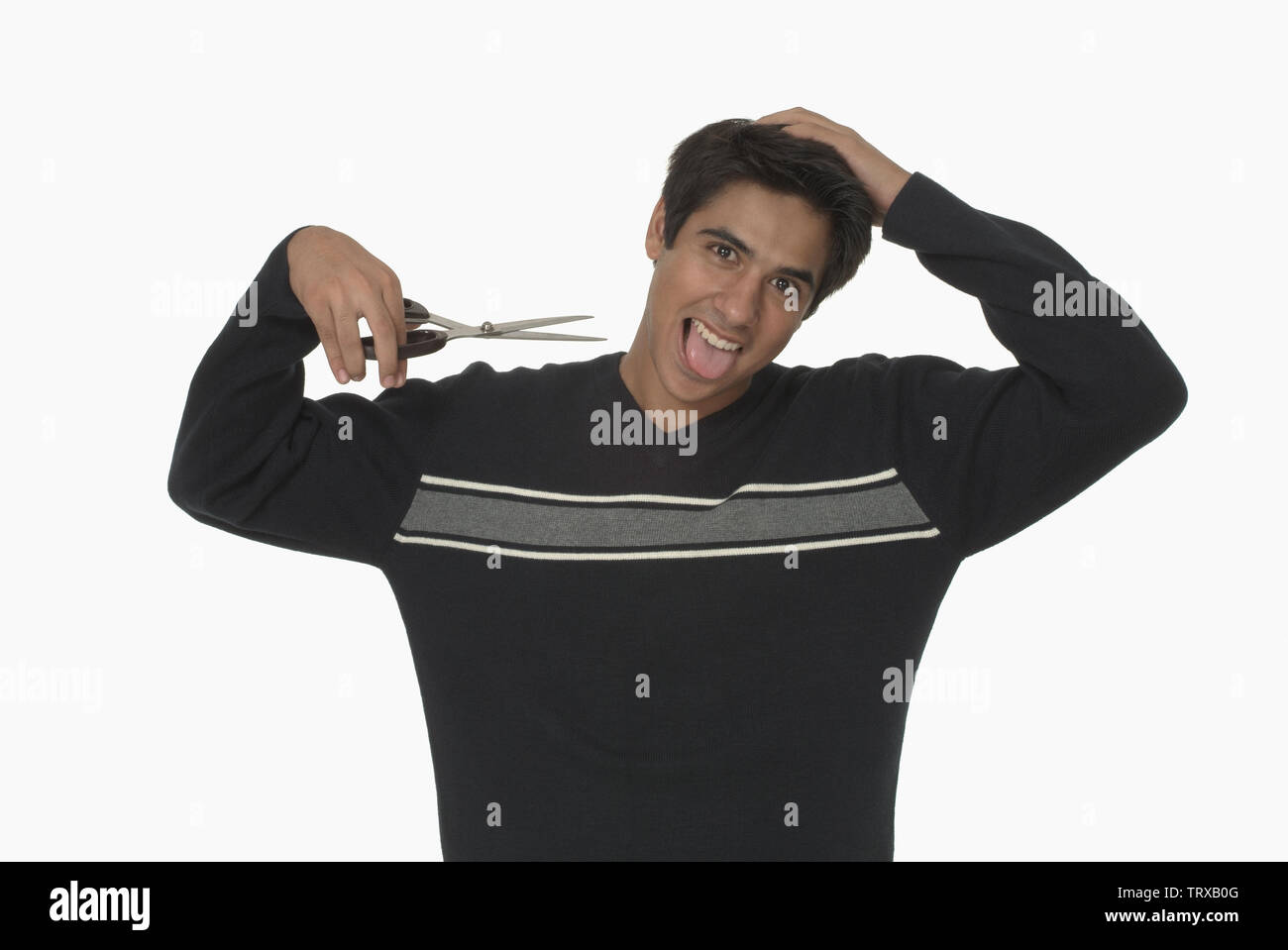 Portrait of a man attempting to cut his neck with scissors Stock Photo ...