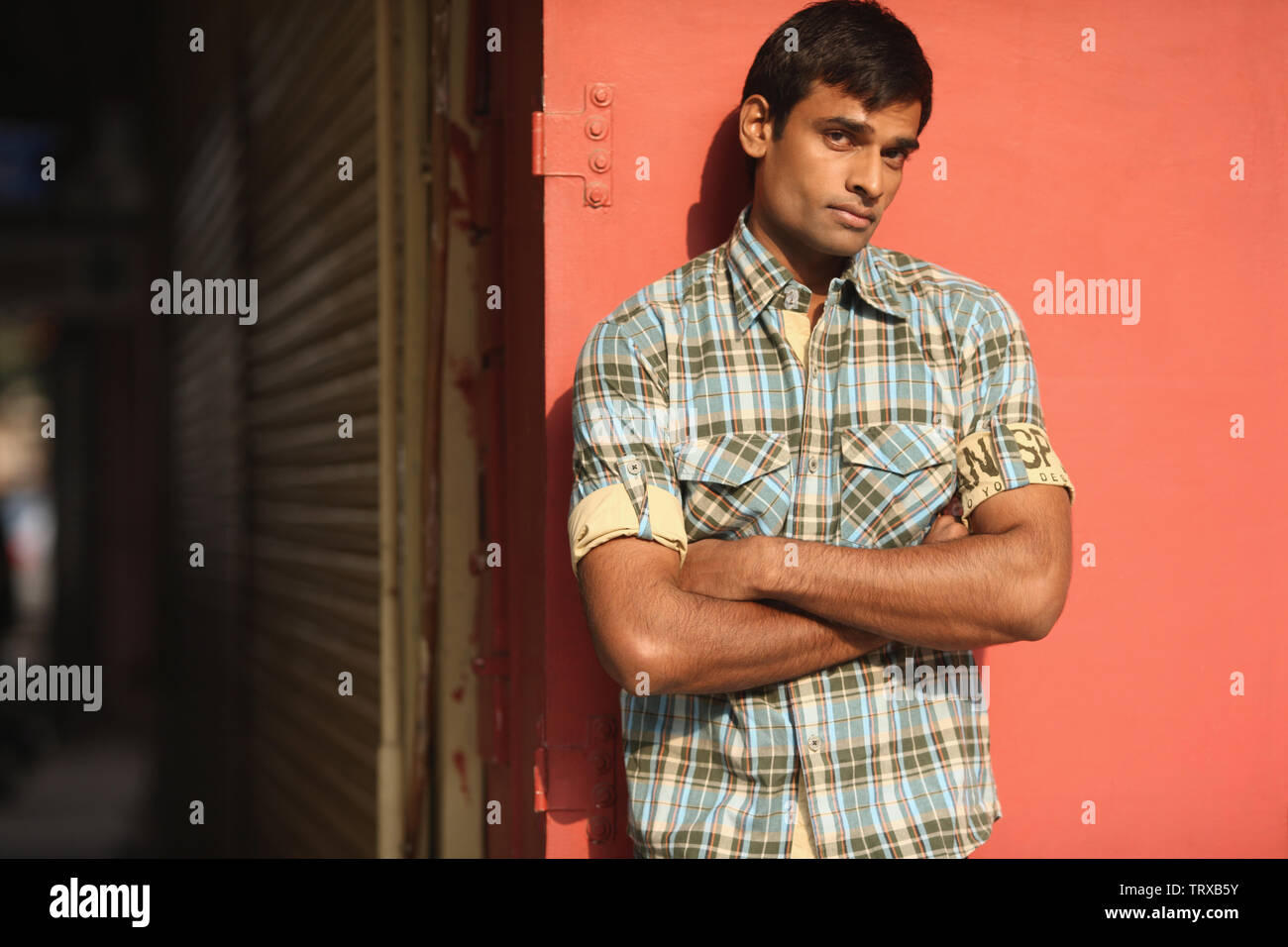 Indian man arms crossed leaning hi-res stock photography and images - Alamy