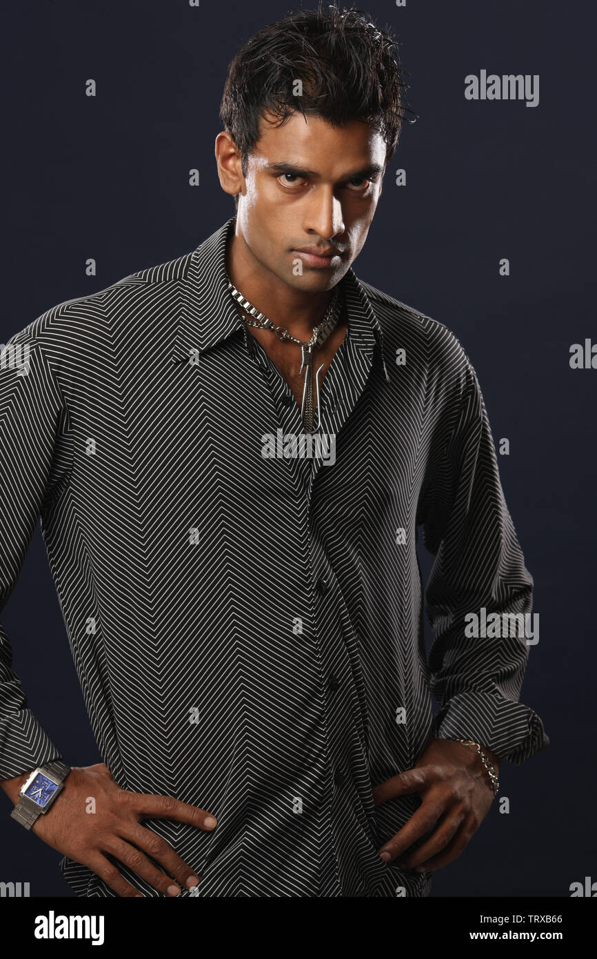 Portrait of a man standing with arms akimbo Stock Photo - Alamy