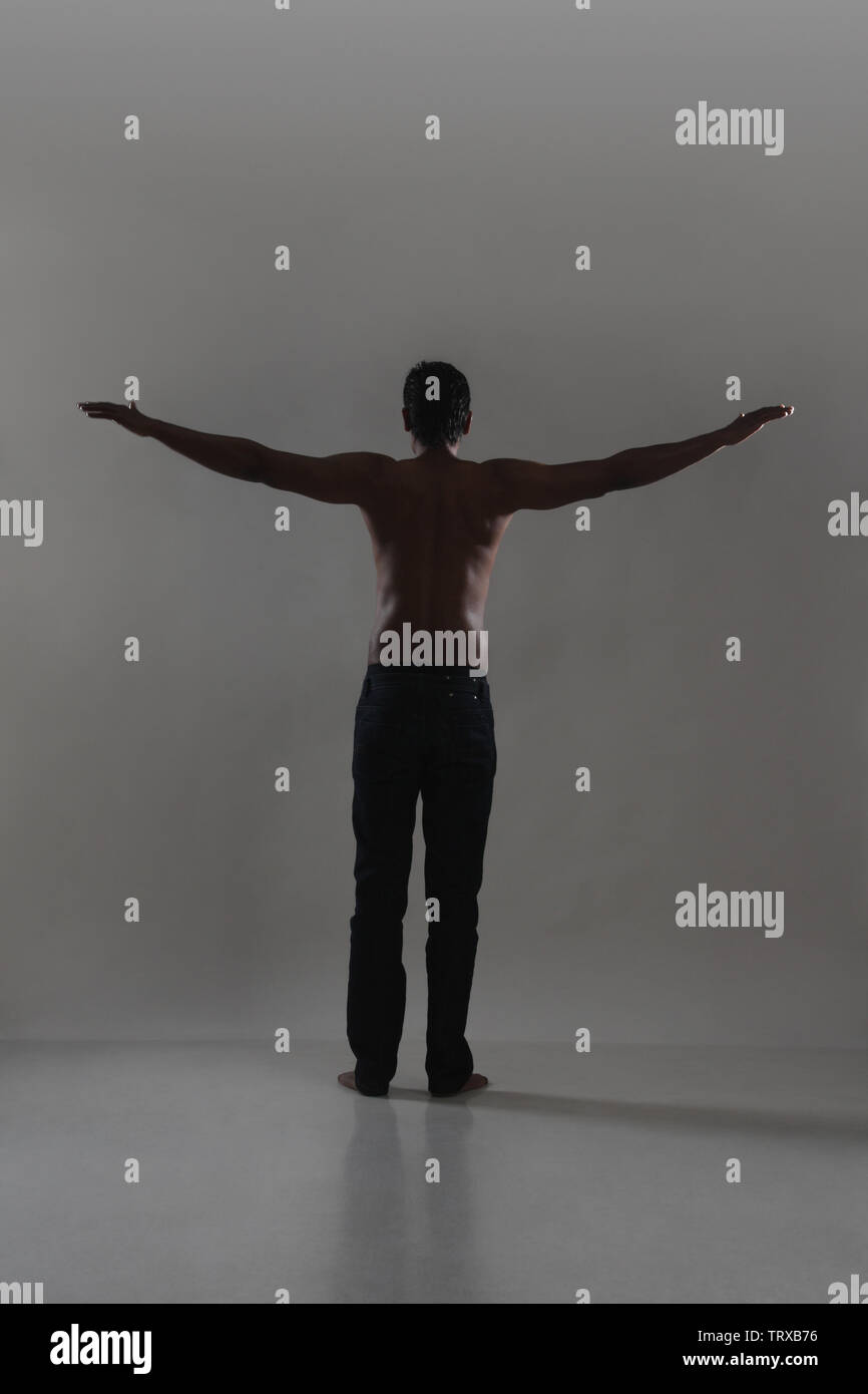 Rear view of a man stretching his arms Stock Photo - Alamy