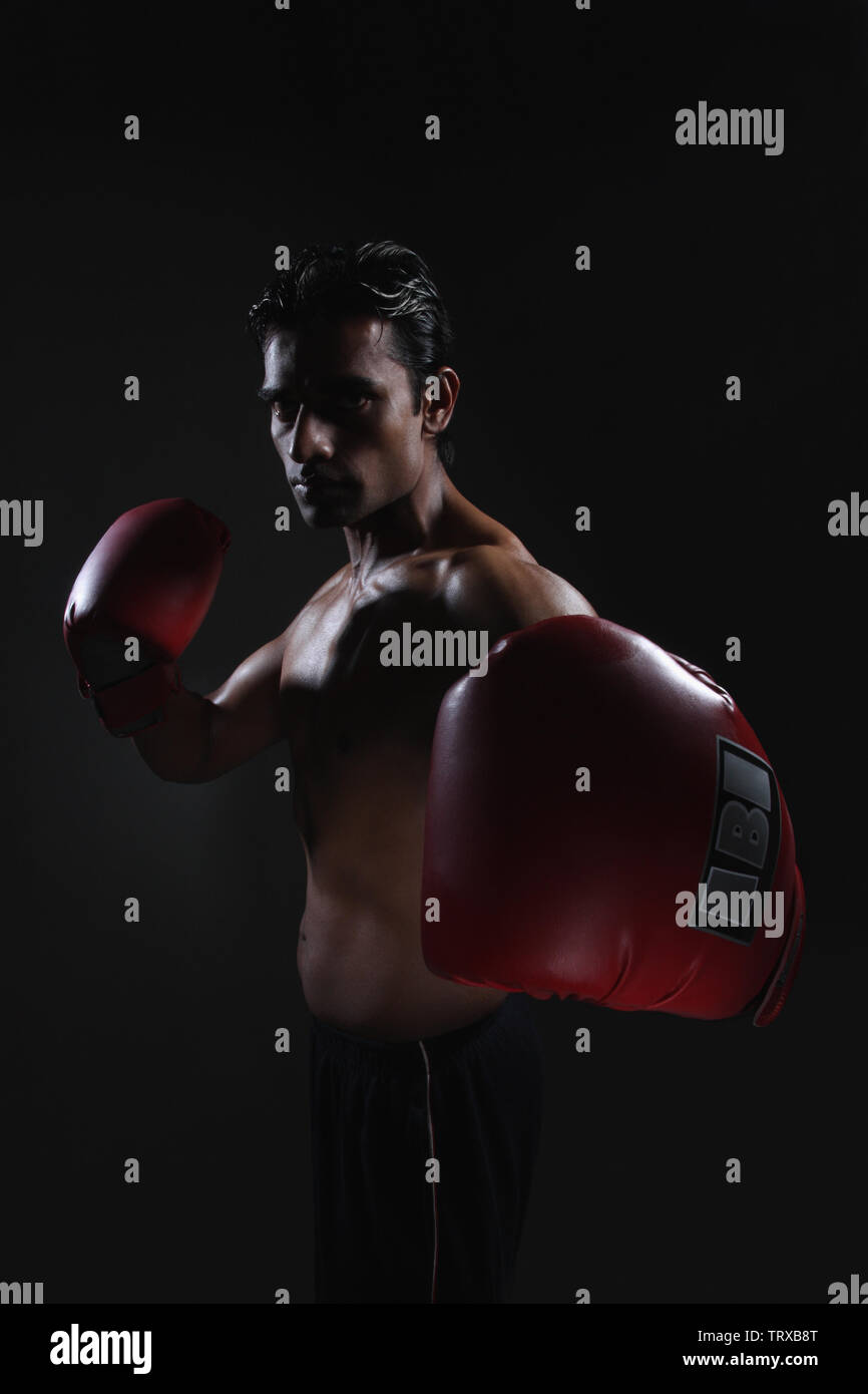 Man wearing boxing gloves Stock Photo - Alamy
