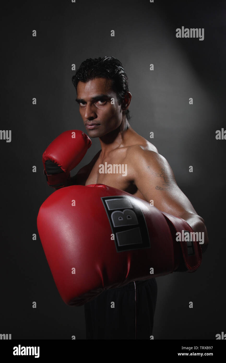 Portrait of a man wearing boxing gloves Stock Photo - Alamy