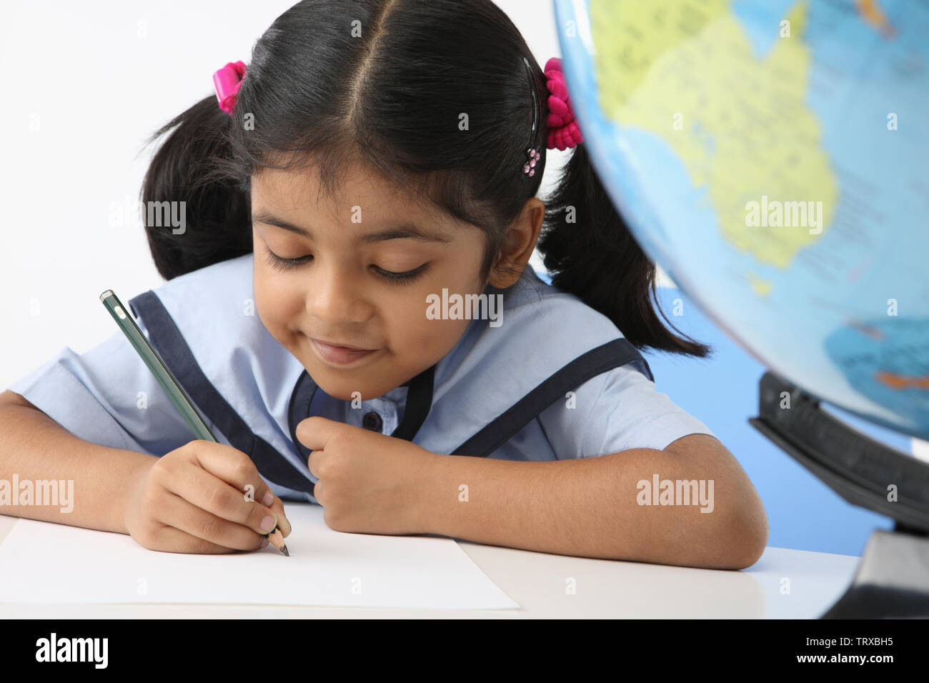 Indian girl writing in a piece of paper Stock Photo - Alamy