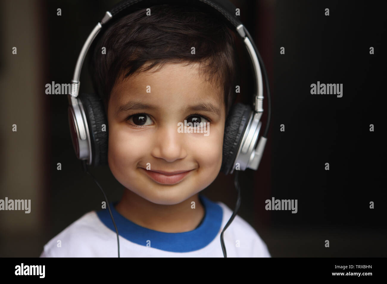Boy listening to music Stock Photo - Alamy