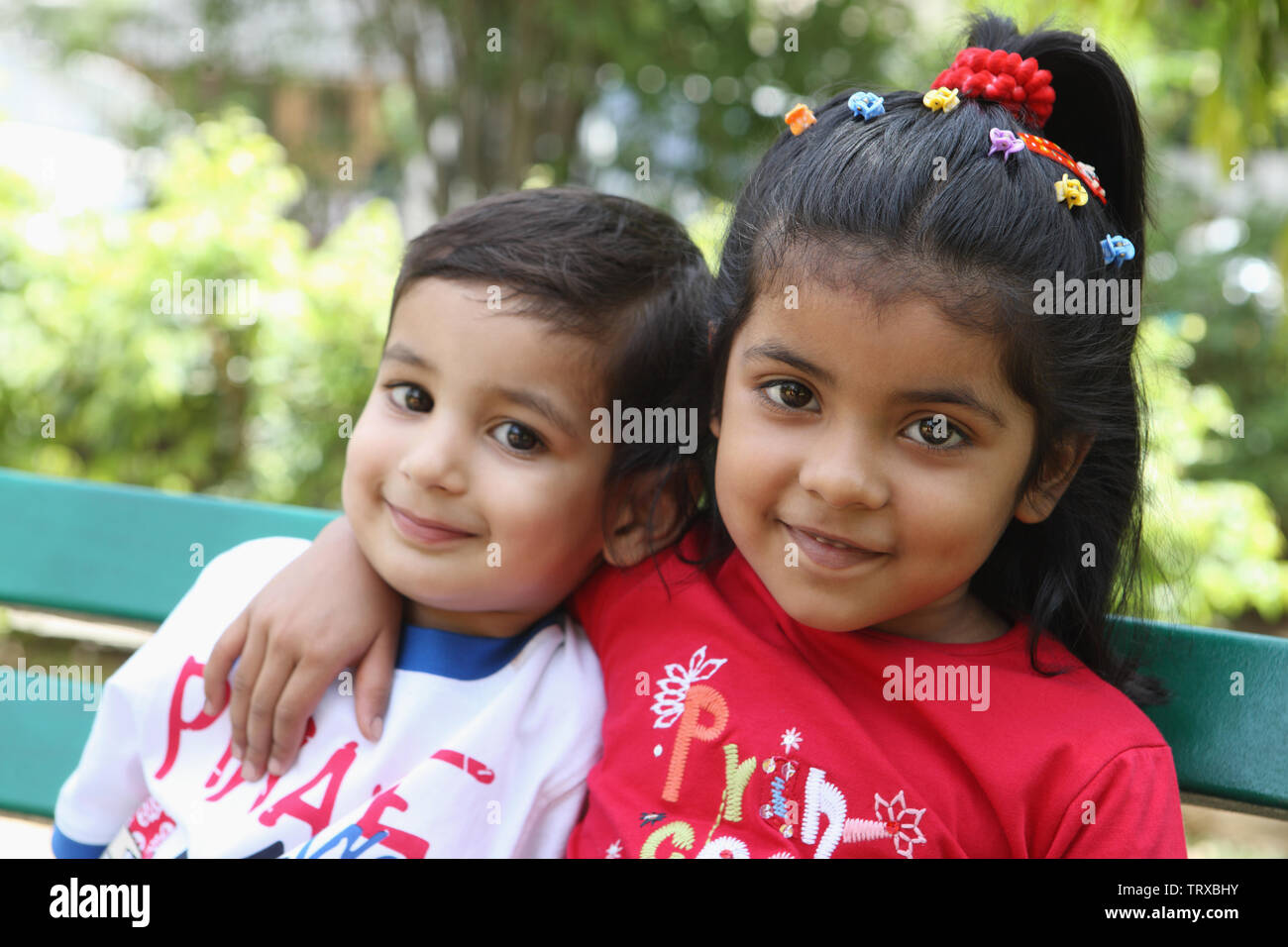 Portrait of two Indian children sitting on a bench Stock Photo - Alamy