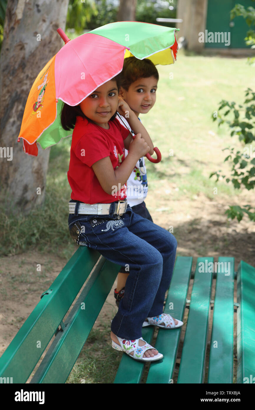 Friends sitting side by side on park bench hi-res stock photography and ...