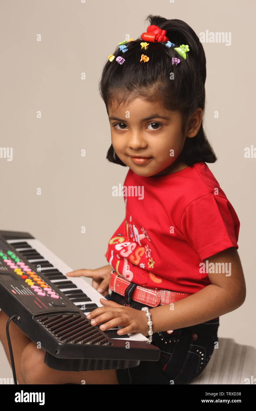 Girl playing a synthesizer Stock Photo - Alamy