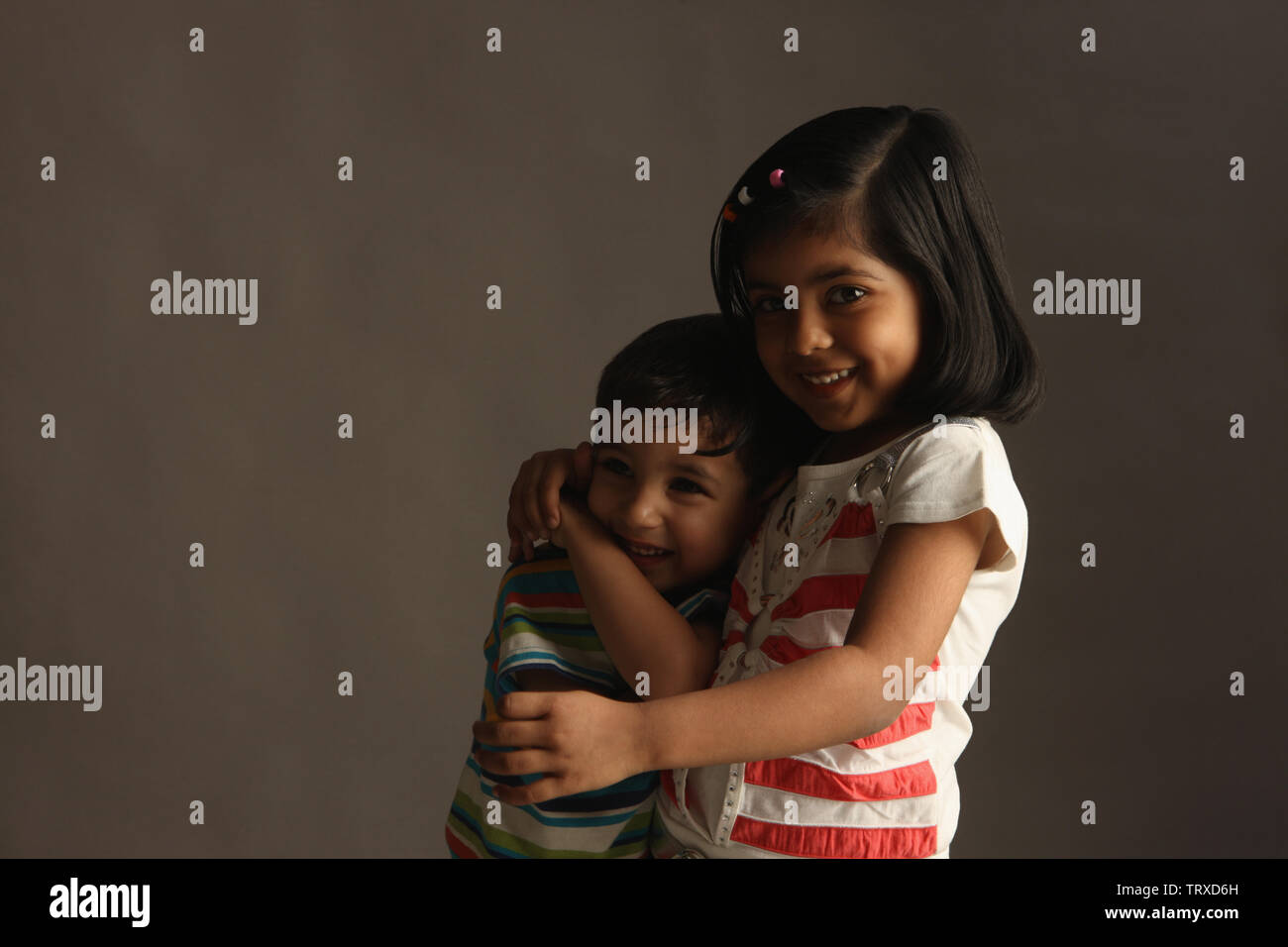 Two children standing together and smiling Stock Photo - Alamy