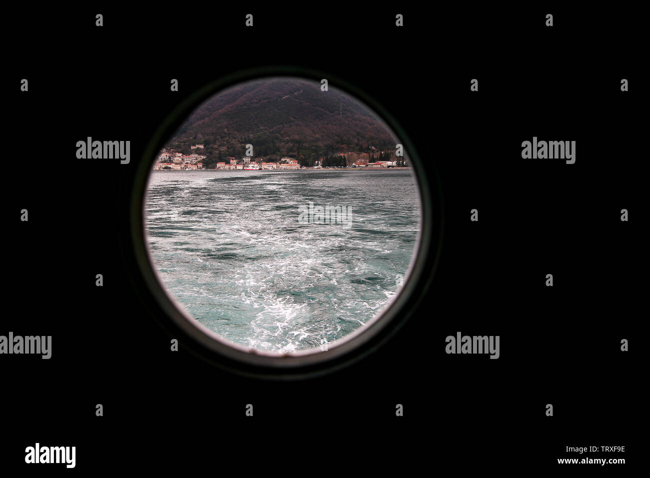 Hinged round window, storm cover on ship looking outside into ...
