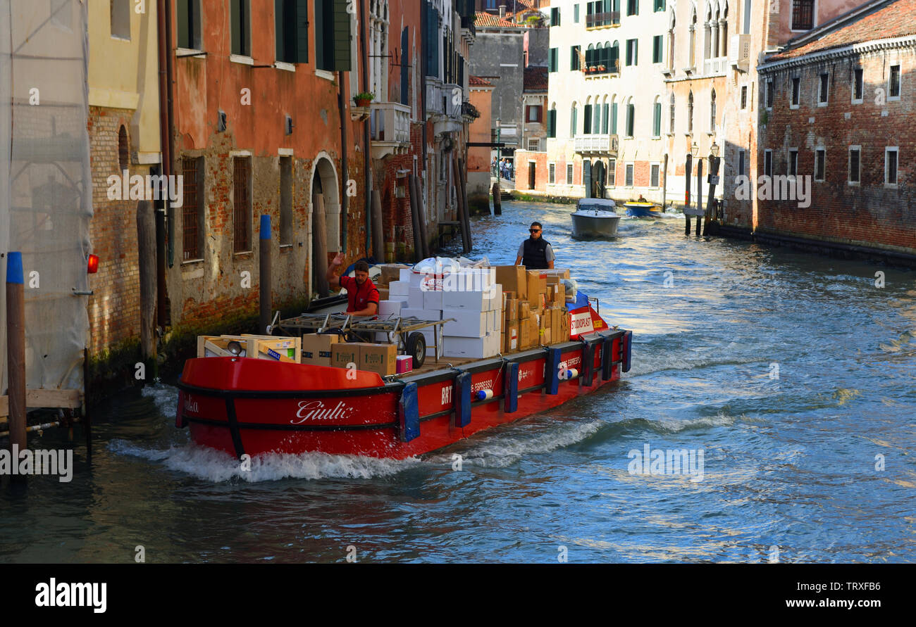 Working delivery boat on Venice canal Stock Photo - Alamy