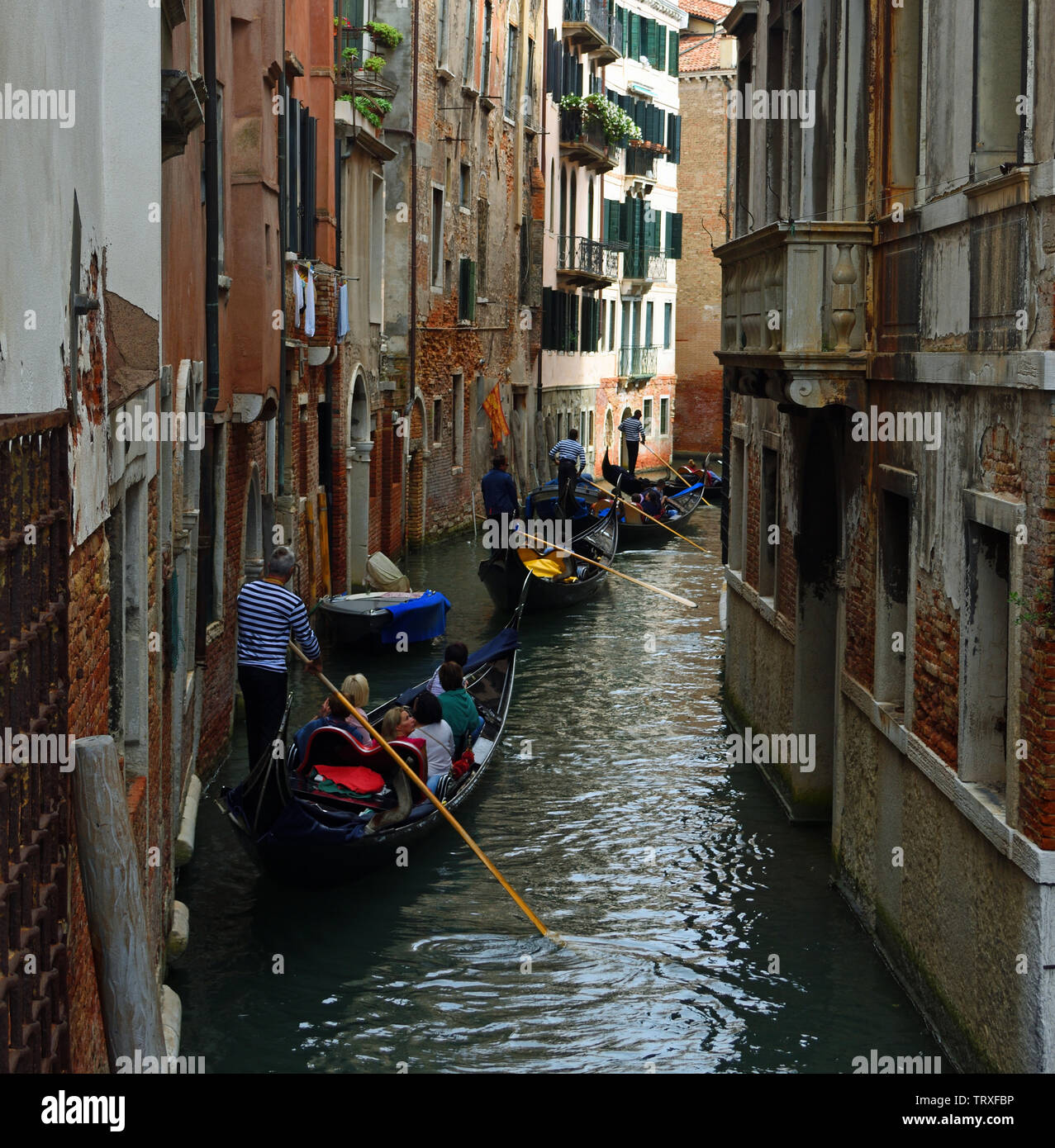 Small Venice canal full of Gondolas with tourists Stock Photo - Alamy