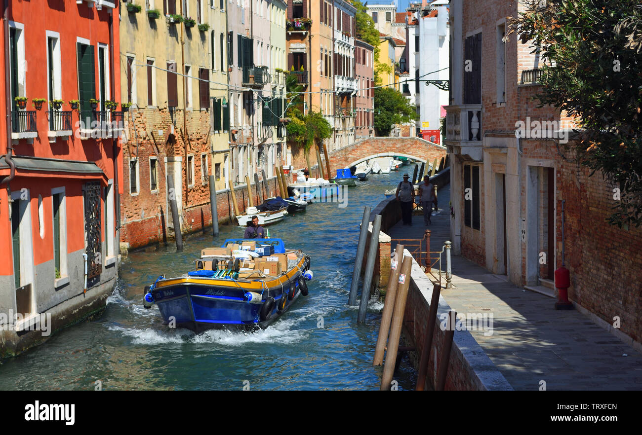 Working delivery boat on Venice canal Stock Photo - Alamy